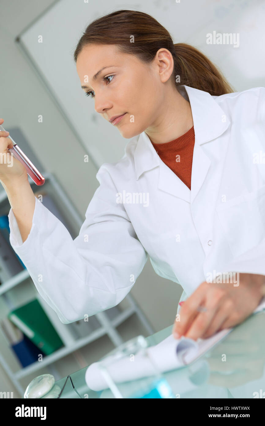 beautiful scientist using a test tube in a lab Stock Photo - Alamy