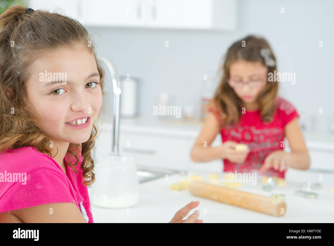 Sisters baking in the kitchen Stock Photo - Alamy