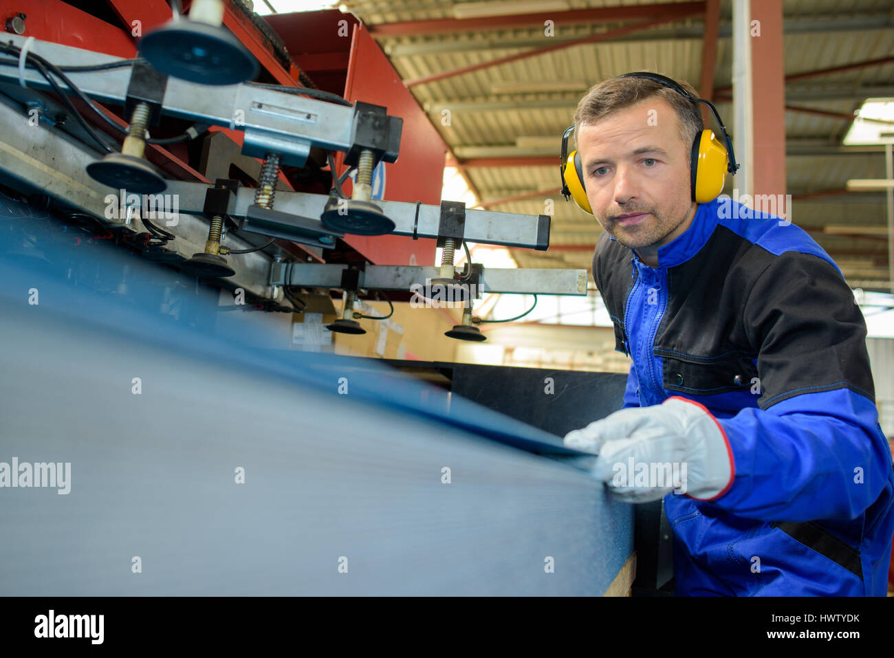 Male operative using machinery Stock Photo - Alamy