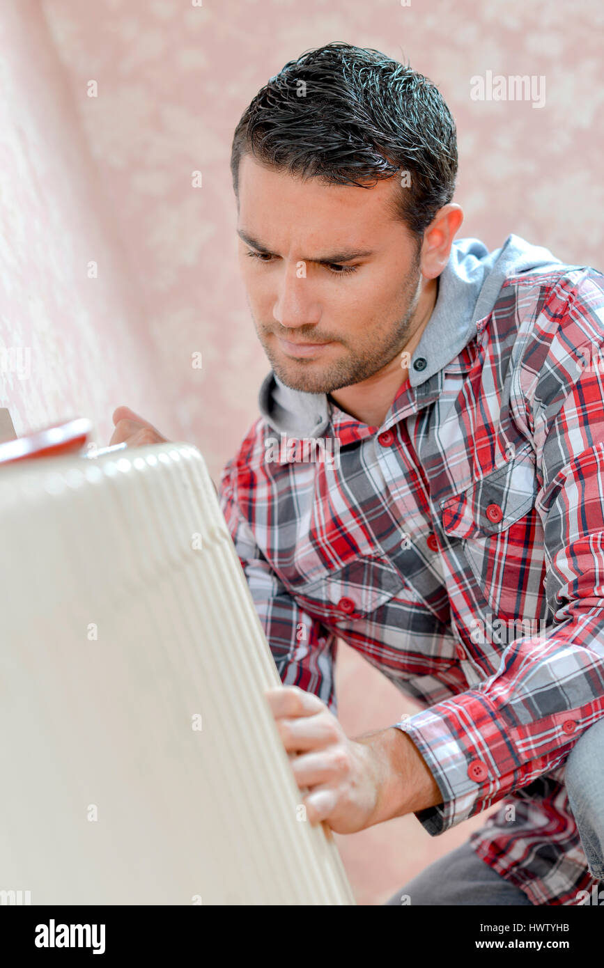 man fixing heater Stock Photo - Alamy