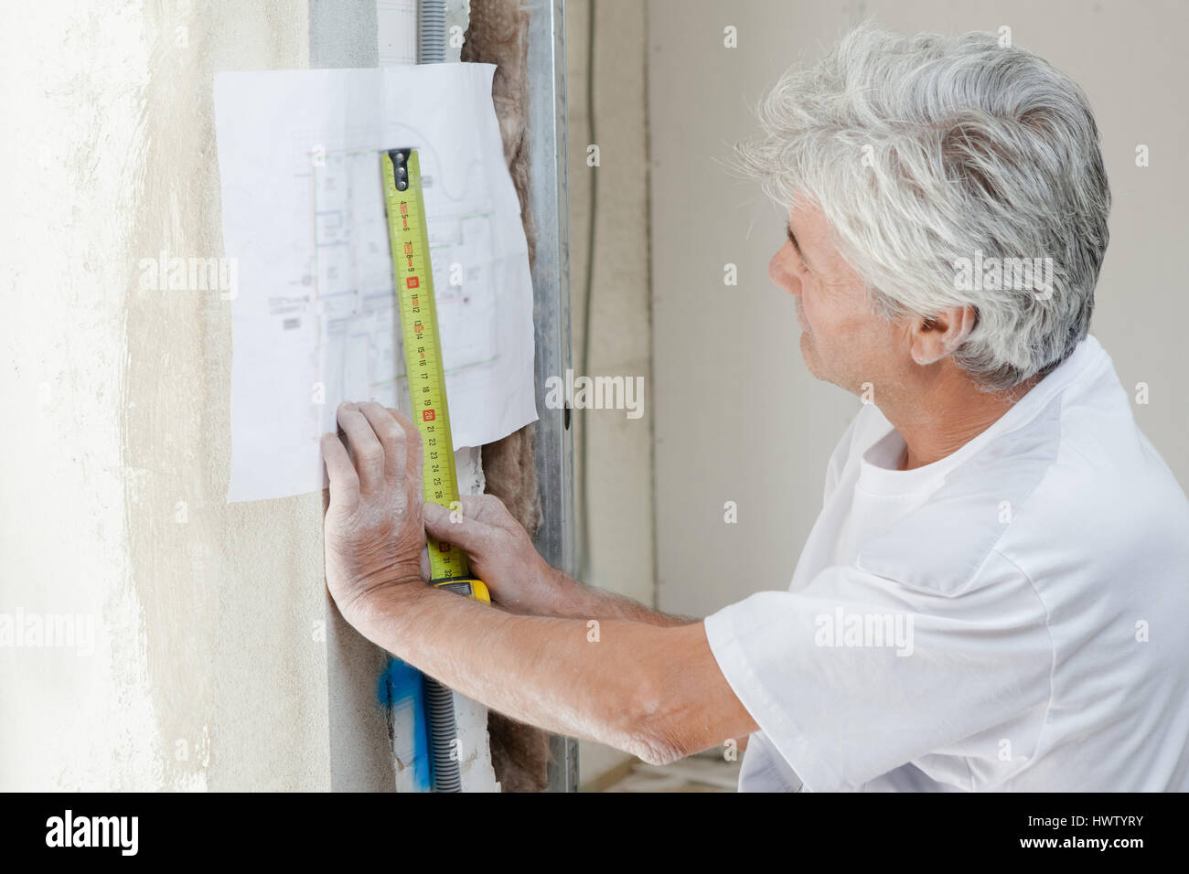 man measuring on a blueprint Stock Photo - Alamy