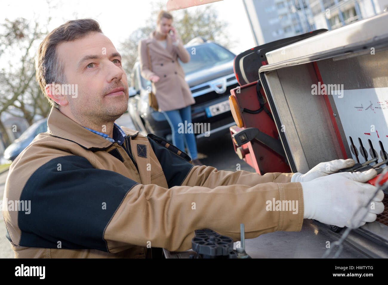 Breakdown man connecting cables Stock Photo - Alamy