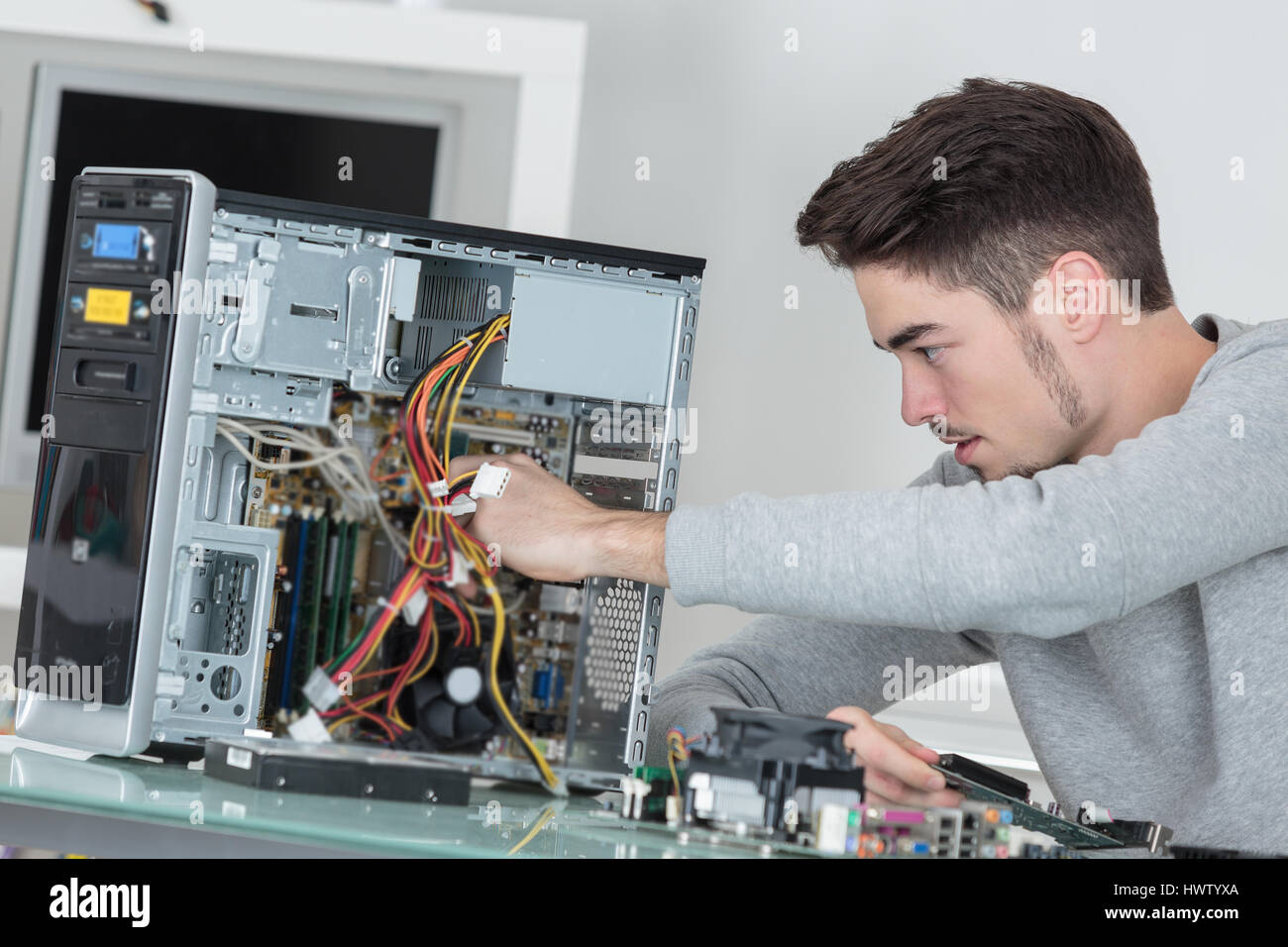 Man working on broken computer Stock Photo - Alamy