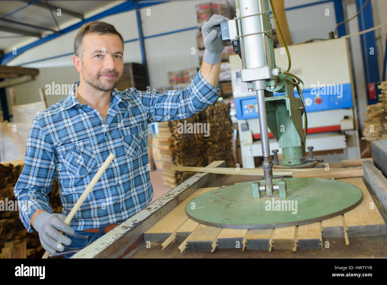 Portrait of man next to woodworking machine Stock Photo - Alamy