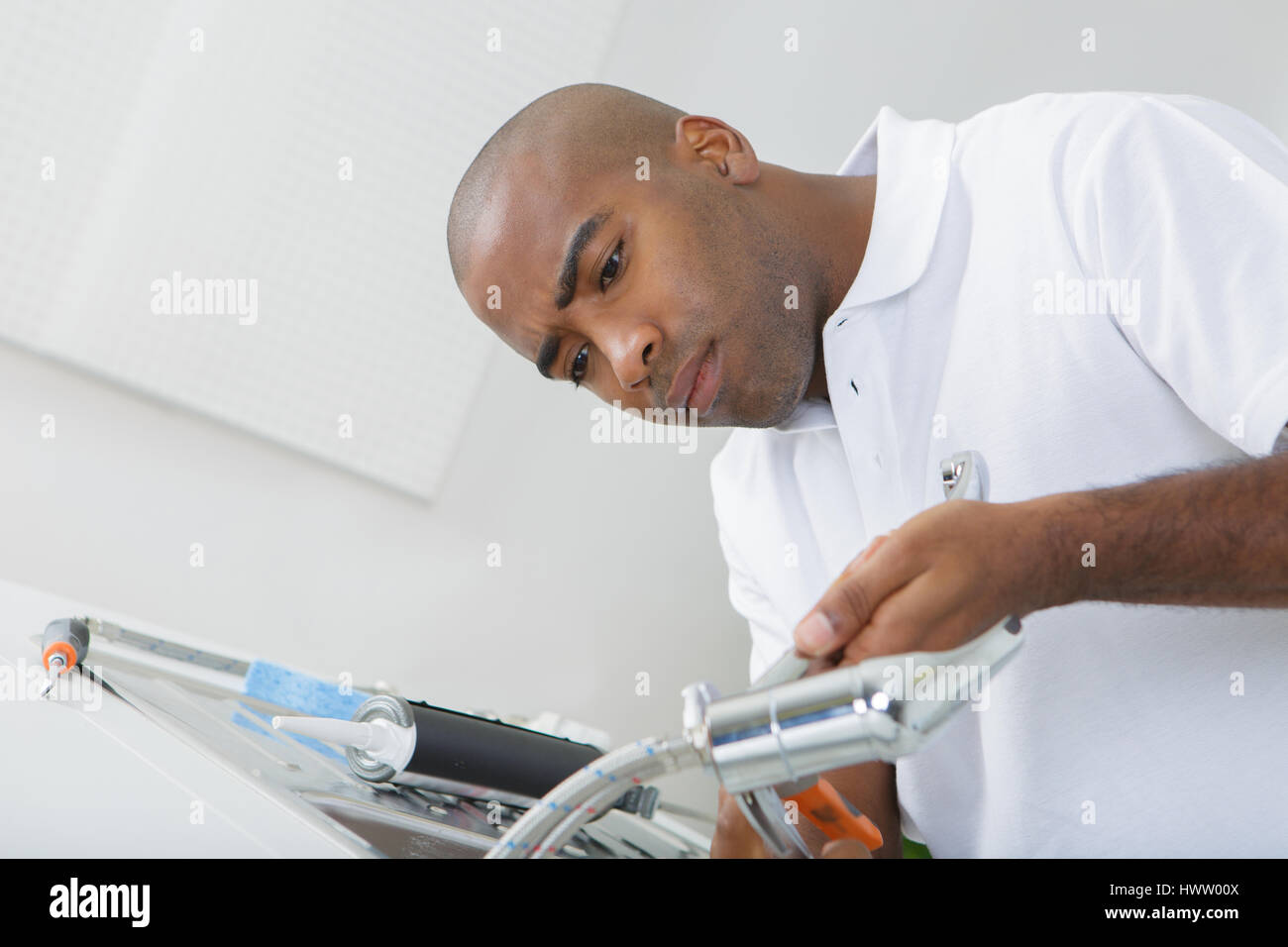 Plumber installing kitchen sink Stock Photo - Alamy