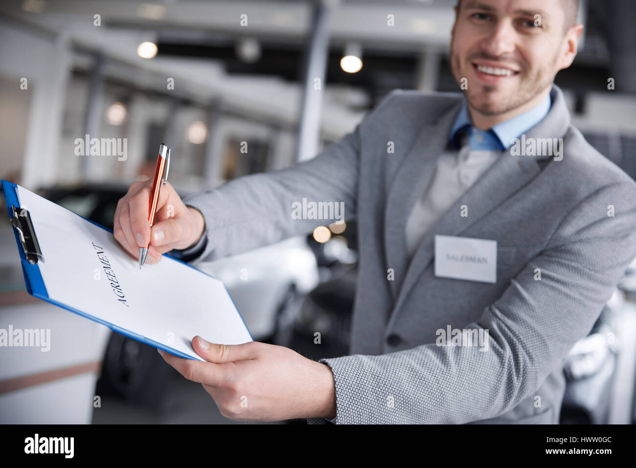 Front view of salesman with agreement Stock Photo - Alamy