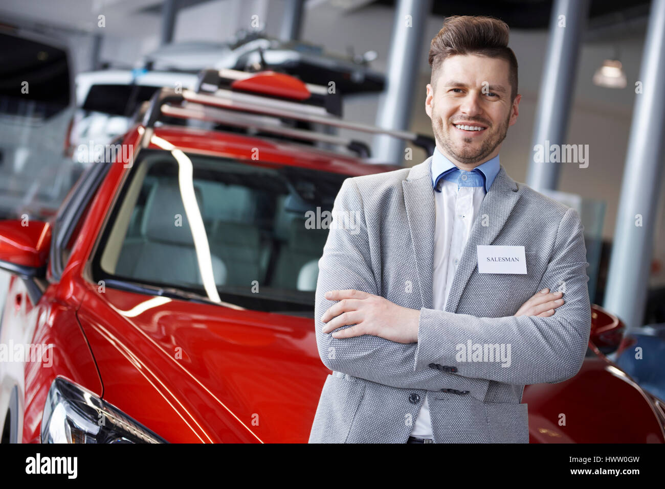 Confident salesman with arms crossed Stock Photo - Alamy