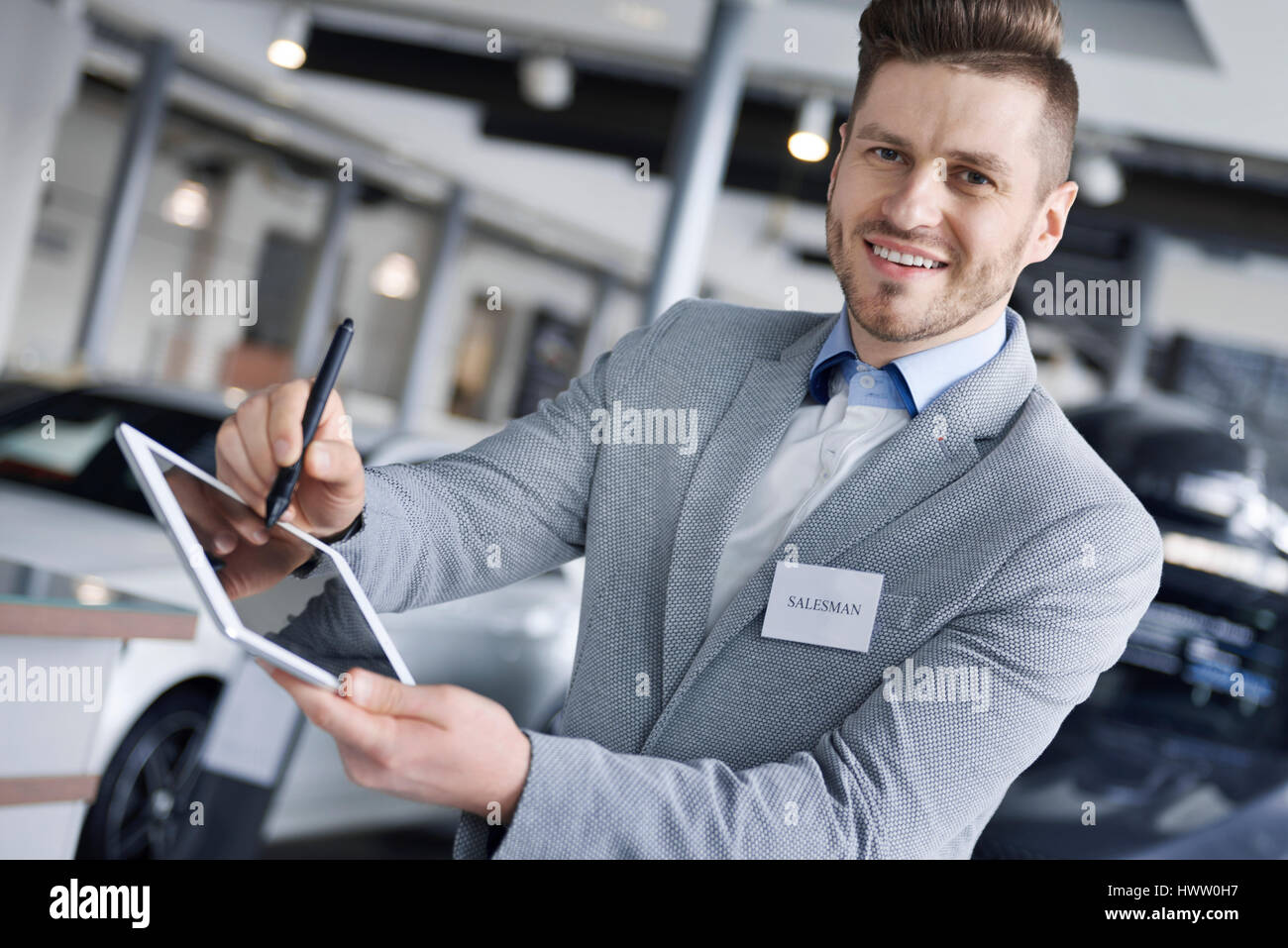 Portrait of salesman holding digital tablet Stock Photo - Alamy