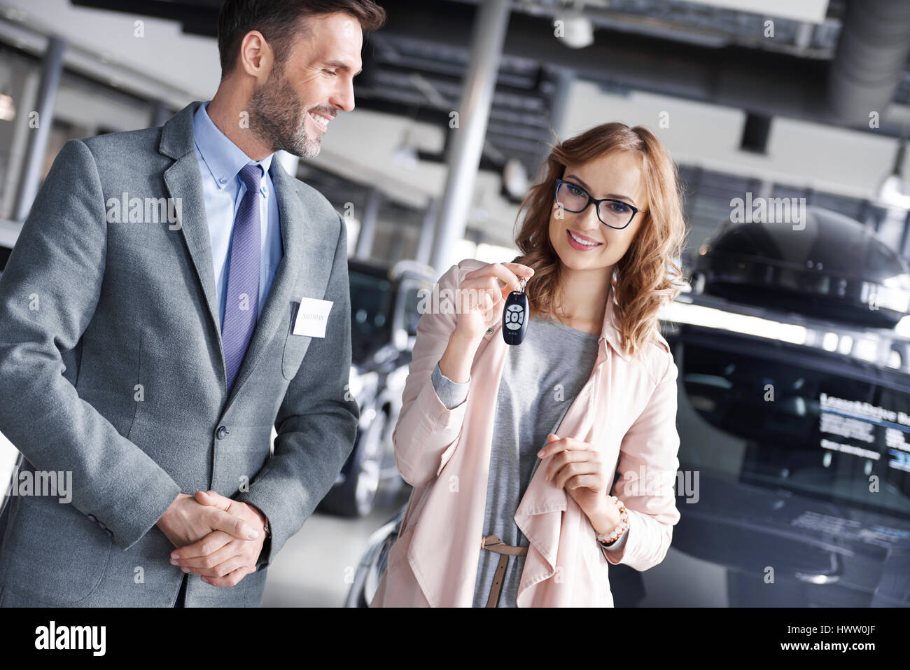 Top view of new female car owner with salesman Stock Photo - Alamy