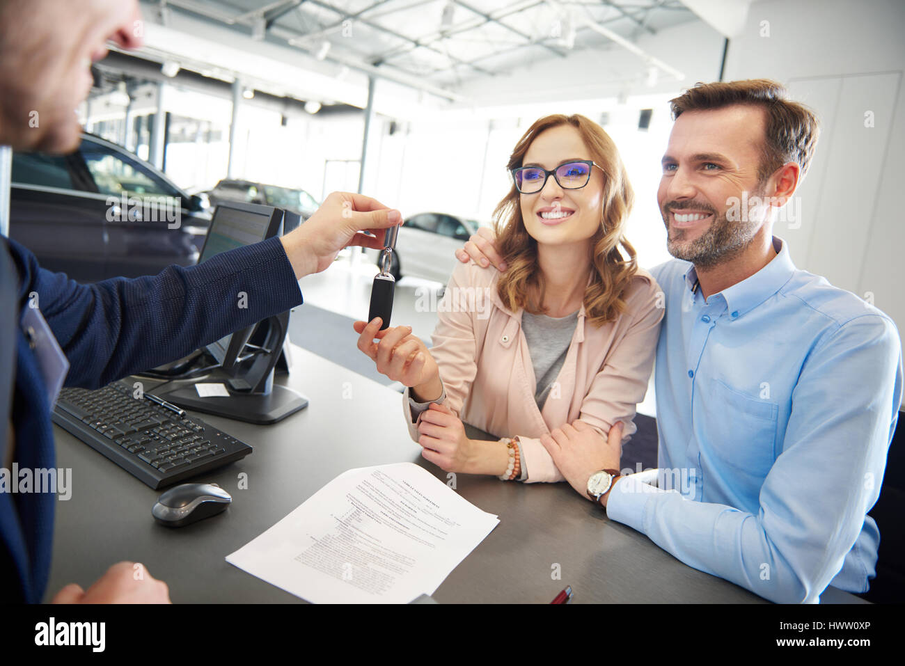 Excited couple receiving car keys Stock Photo - Alamy