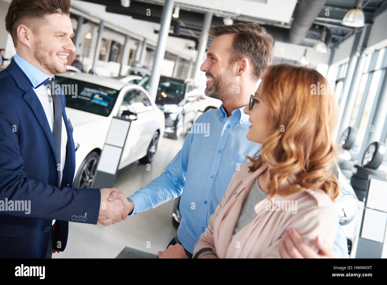 Handshake between male customer and salesman Stock Photo - Alamy