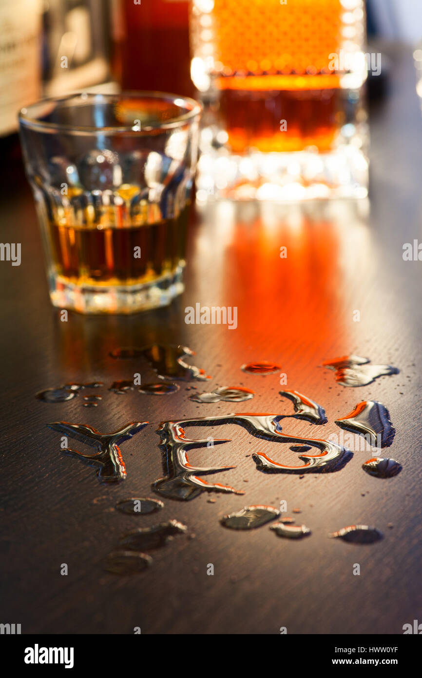 The word Yes written with spoiled whiskey on a bar counter Stock Photo ...