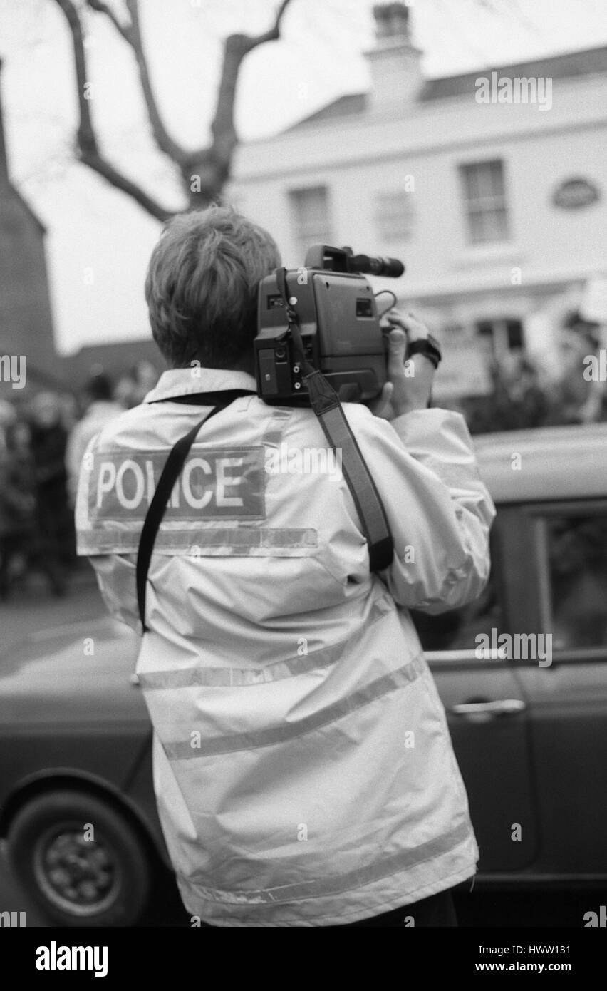 A police officer videos anti fox hunting protestors at the Boxing Day ...