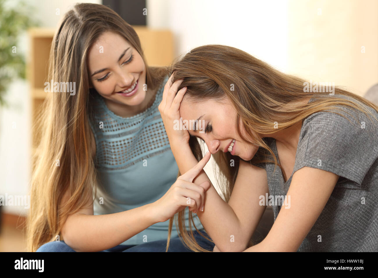 Girl trying to comfort and making laugh to her sad best friend after a ...