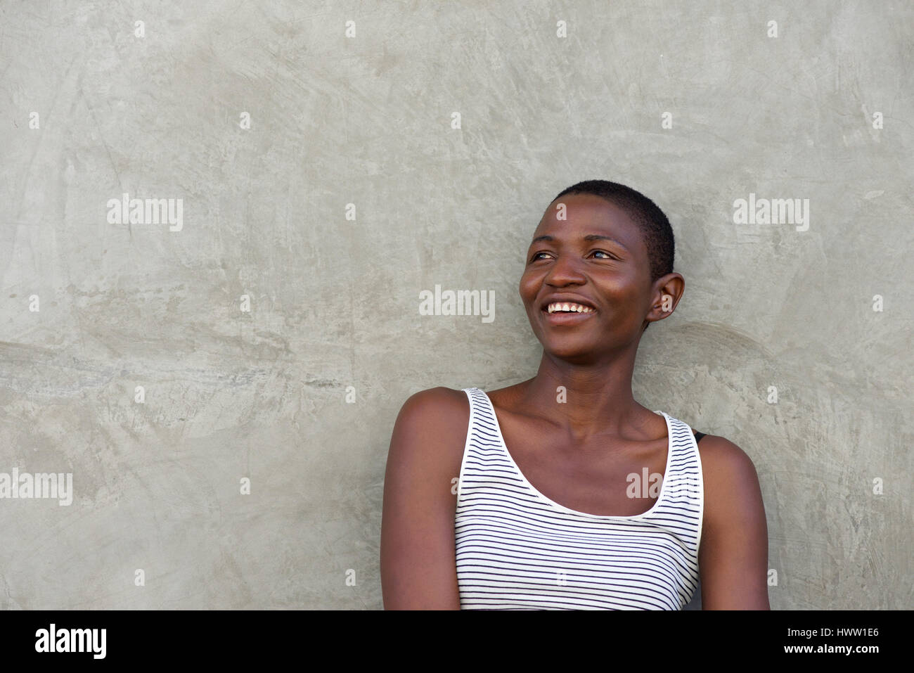 Close up portrait of laughing beautiful black woman leaning against ...