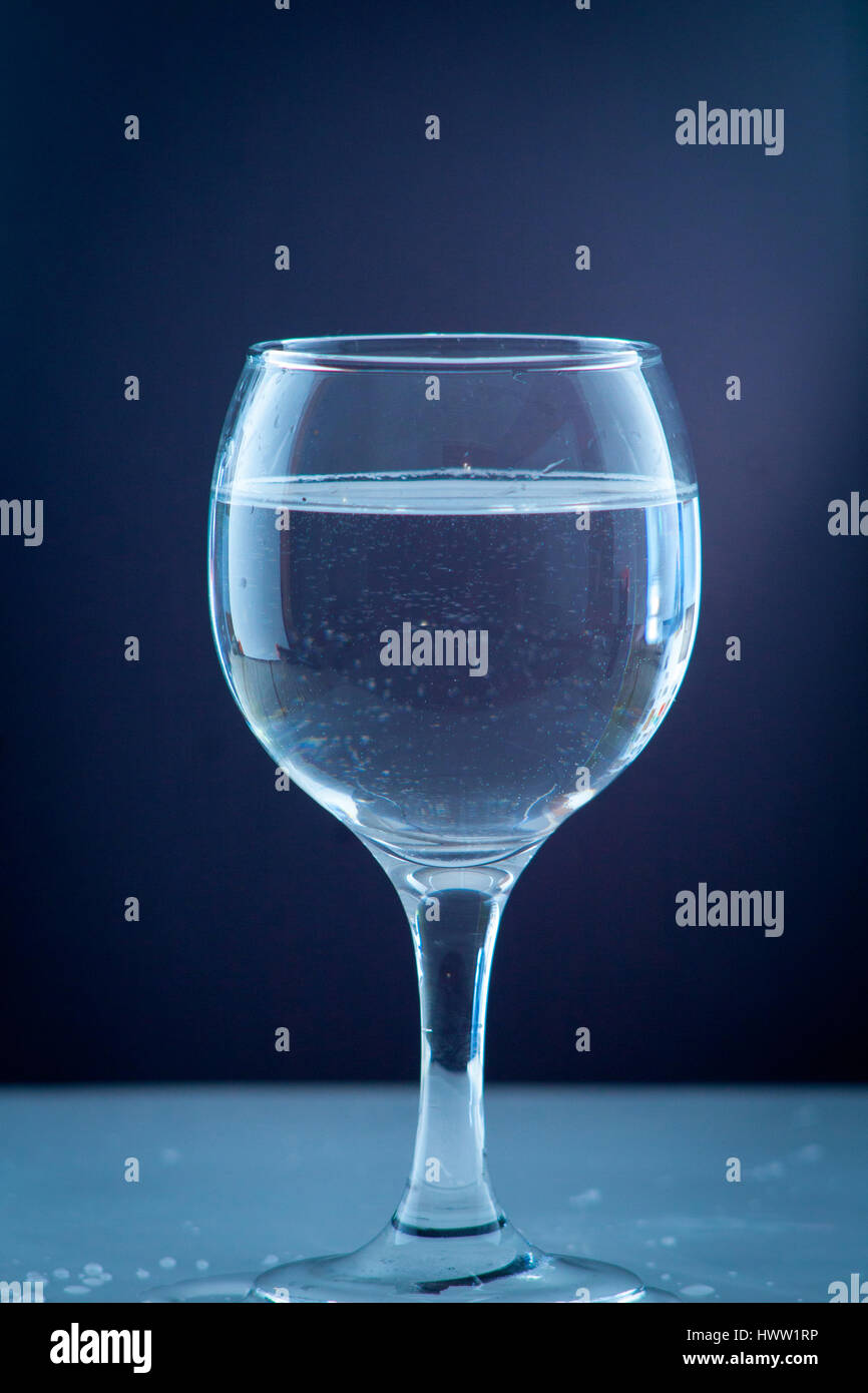 Clean drinking water from a source pouring into a clear glass beaker in ...