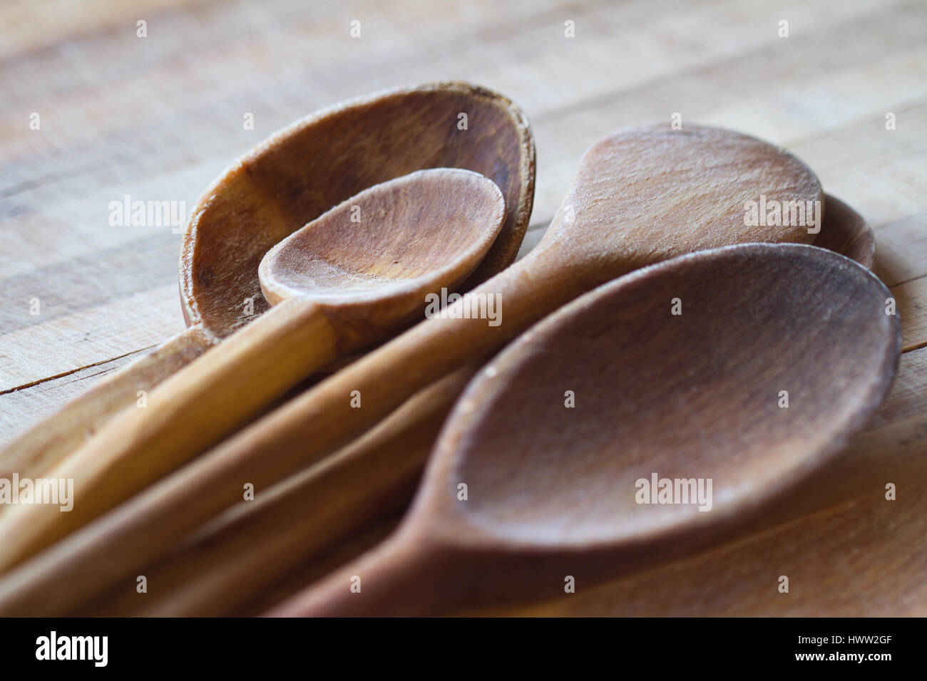 side view of hand crafted wooden kitchen spoons in many sizes and ...