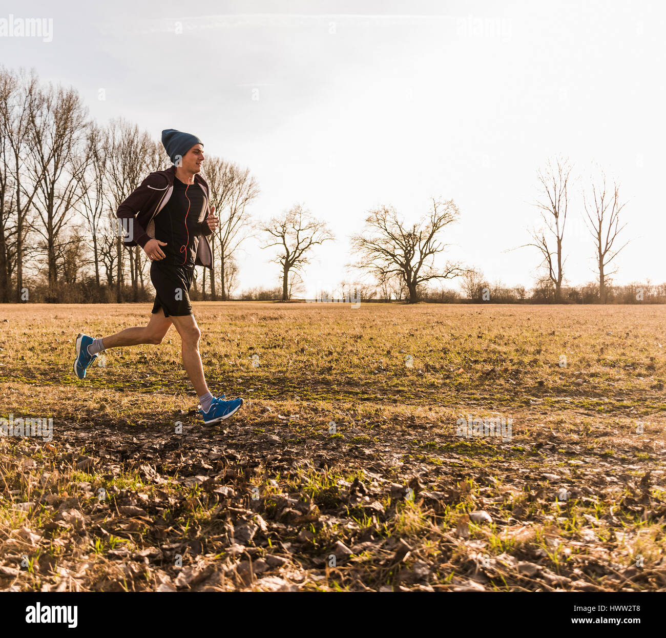 Man running in rural landscape Stock Photo - Alamy