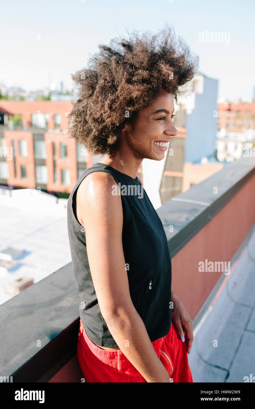 Relaxed woman standing on rooftop in Brooklyn Stock Photo - Alamy