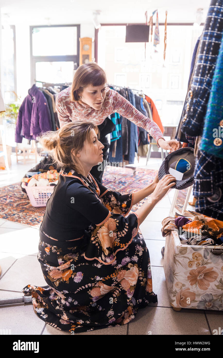 Two women in a second hand shop Stock Photo - Alamy