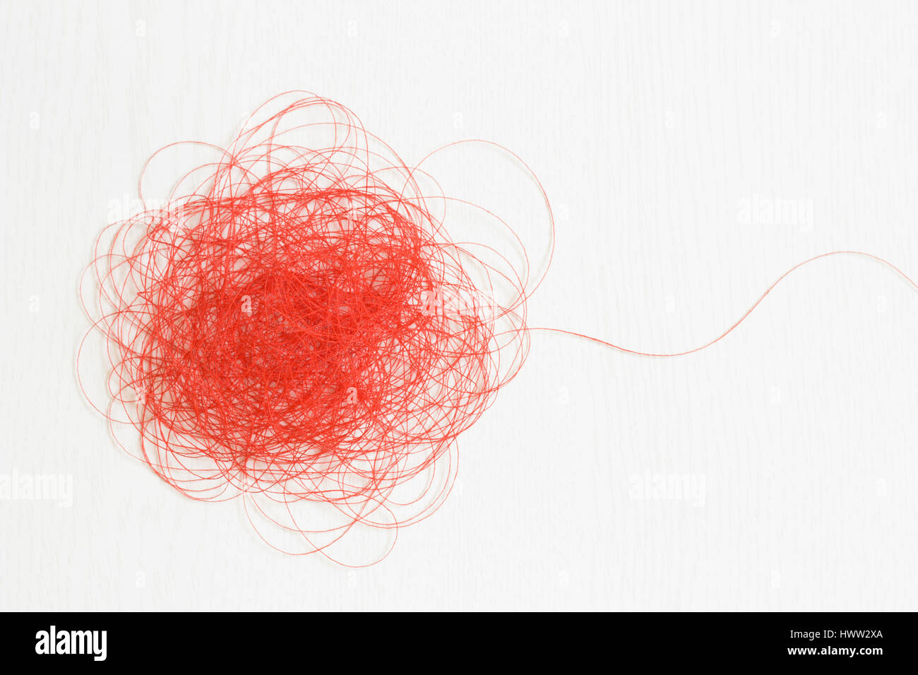 Red thread on white background Stock Photo - Alamy