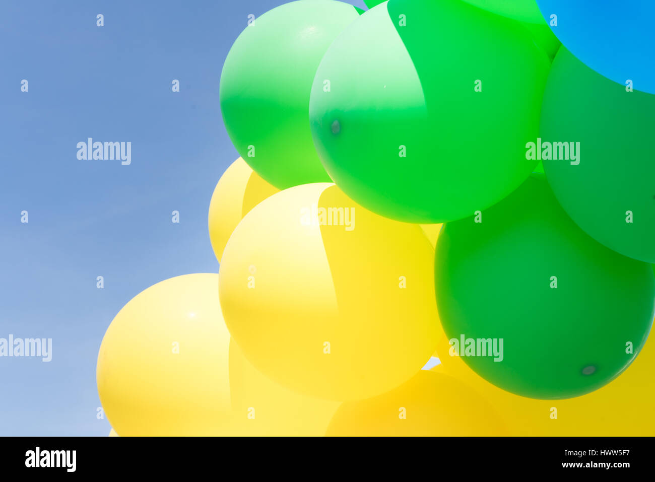 Multi colour balloons in a bunch floating in the sky Stock Photo - Alamy