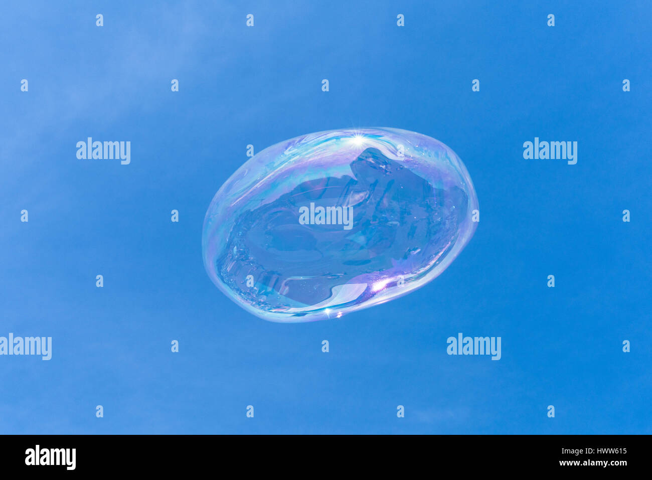 A soap bubble floating in the blue sky with reflections Stock Photo - Alamy