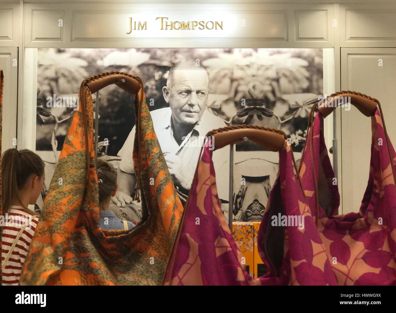 A portrait of American entrepreneur Jim Thompson can be seen behind ...