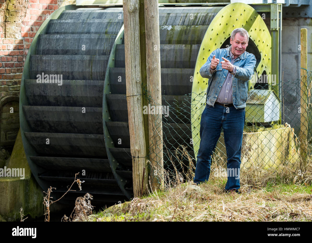 Mill owner Jan Bauditz stands next to the water wheel of his mill in ...