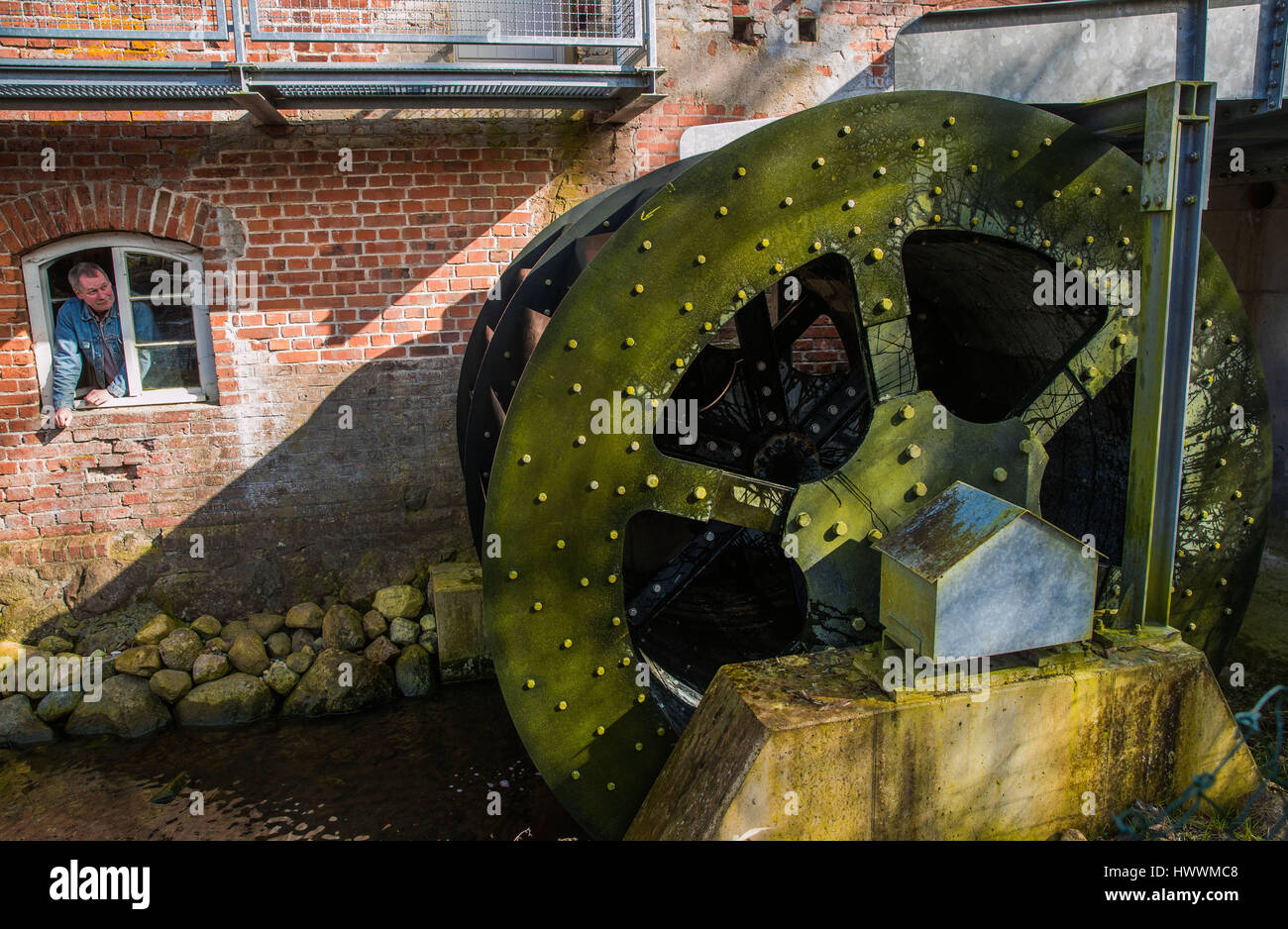 Mill owner Jan Bauditz looks at the water wheel of his mill in Rueting ...