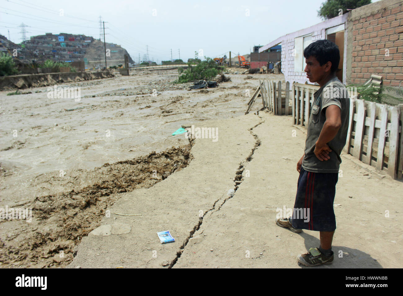 A man looks at the high water of the Chillon river in Lima, Peru, 17 ...