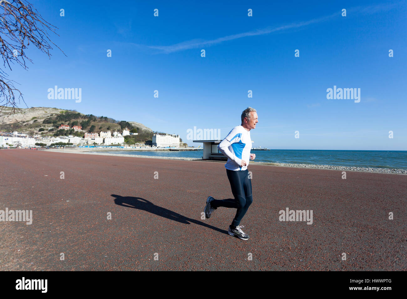 Man running alone along the promenade at the popular seaside town of ...