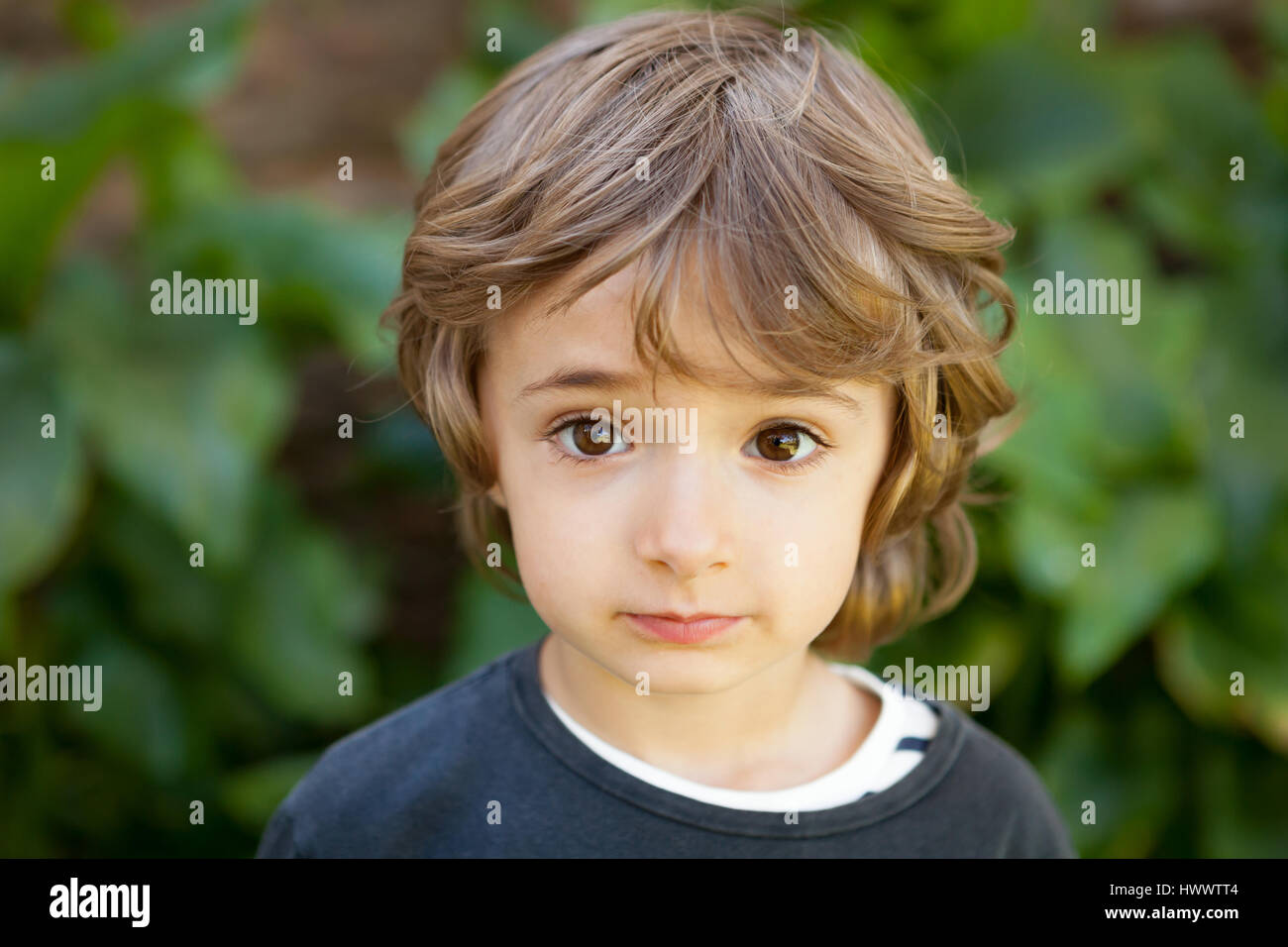 Adorable small child in the field looking at camera Stock Photo - Alamy
