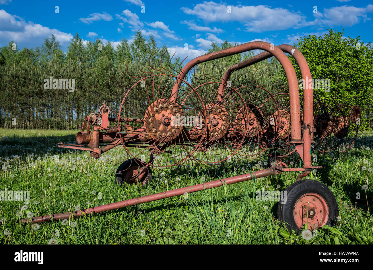Old type of hay turner machine in Poland Stock Photo - Alamy