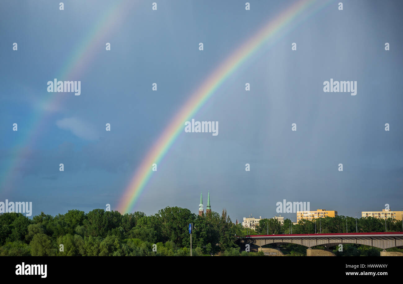 Rainbow over Warsaw city in Poland Stock Photo - Alamy