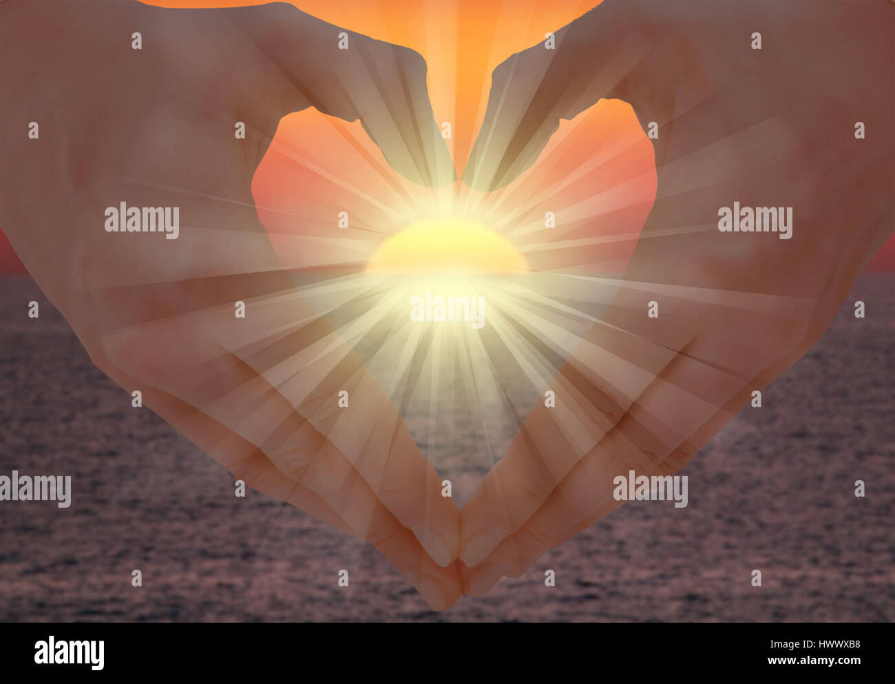 joined hands in a heart shape on sunset at sea Stock Photo - Alamy