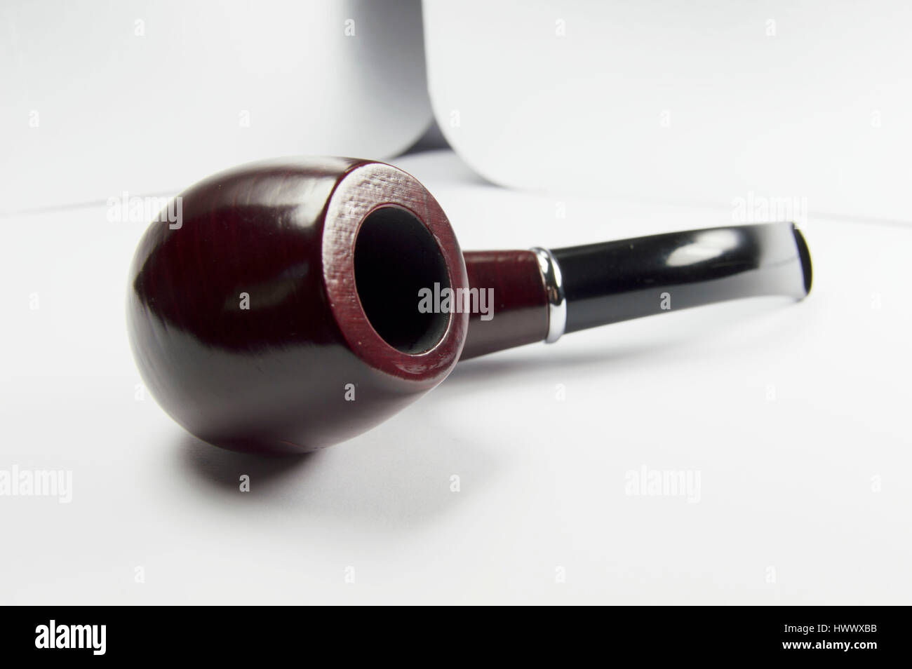 red wooden pipe on white background Stock Photo - Alamy