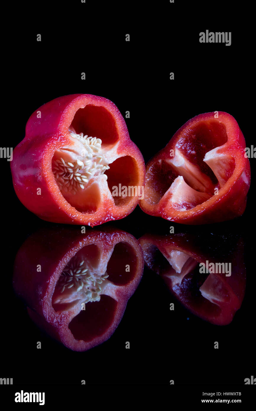 A single sweet bell pepper cut in half Stock Photo - Alamy