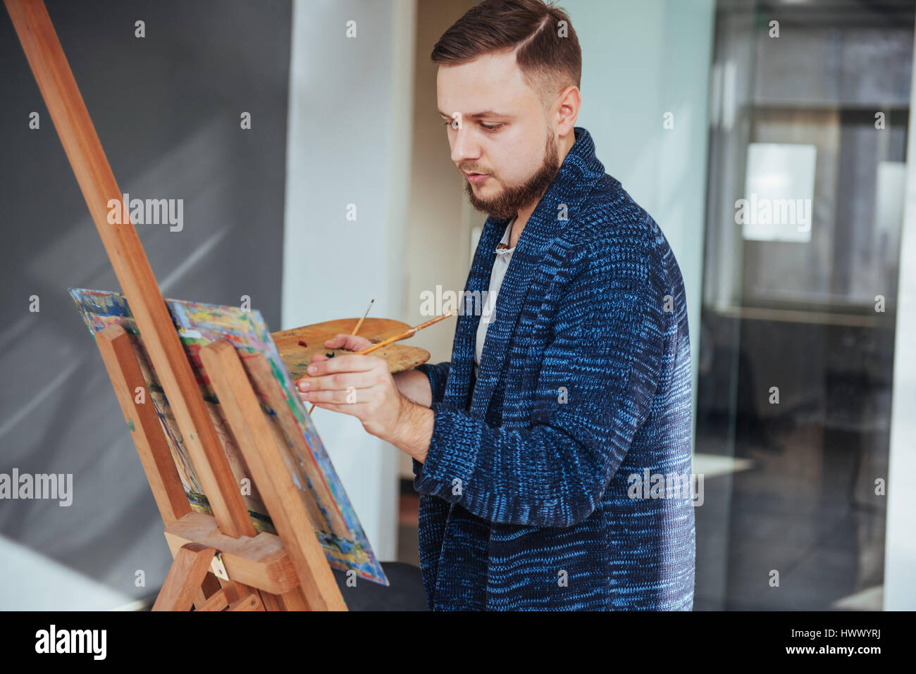 artist painting a picture in a studio Stock Photo - Alamy