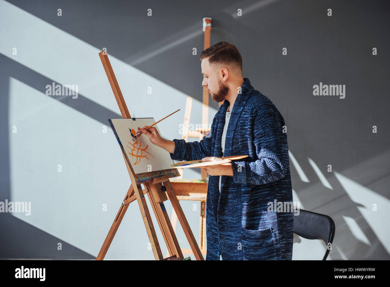 artist painting a picture in a studio Stock Photo - Alamy