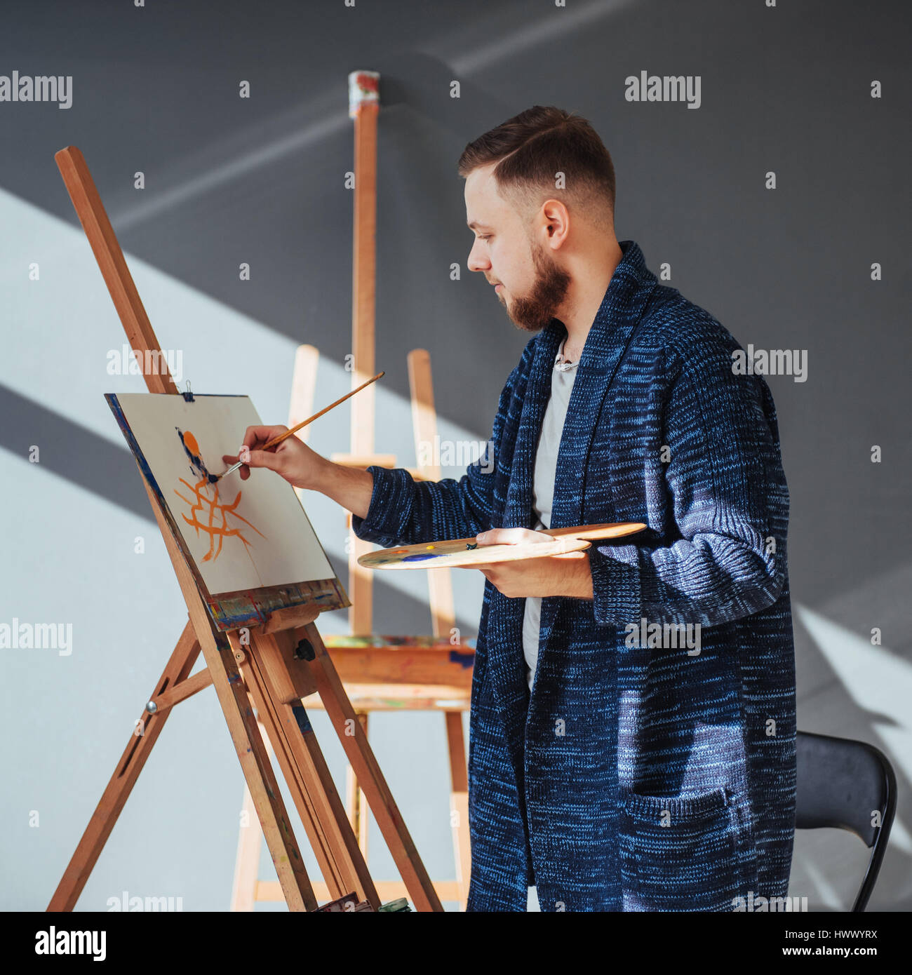 artist painting a picture in a studio Stock Photo - Alamy