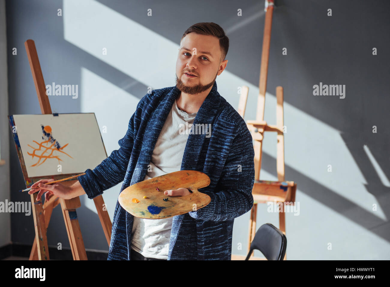 artist painting a picture in a studio Stock Photo - Alamy