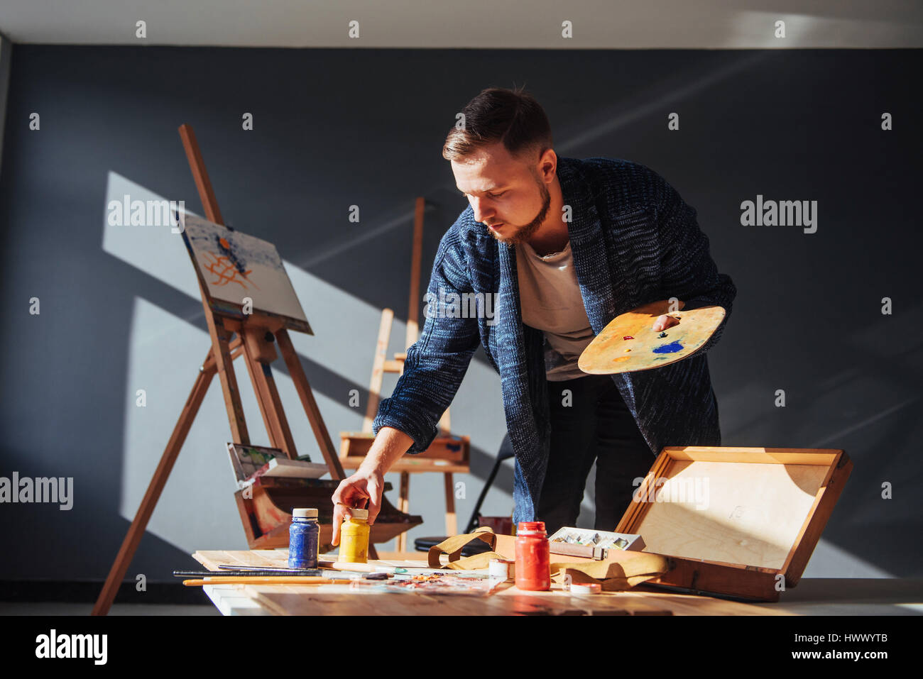 artist painting a picture in a studio Stock Photo - Alamy