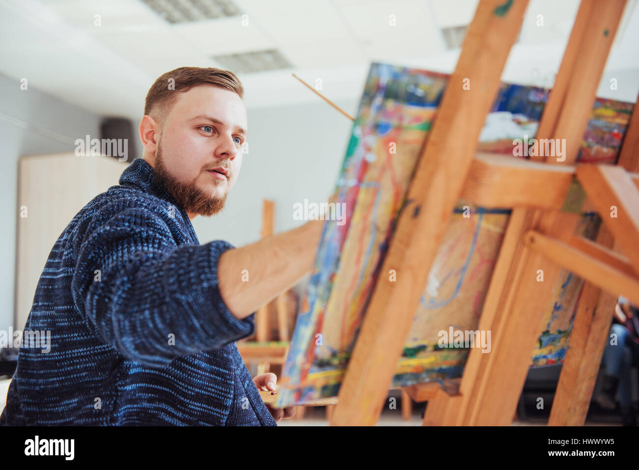 artist painting a picture in a studio Stock Photo - Alamy