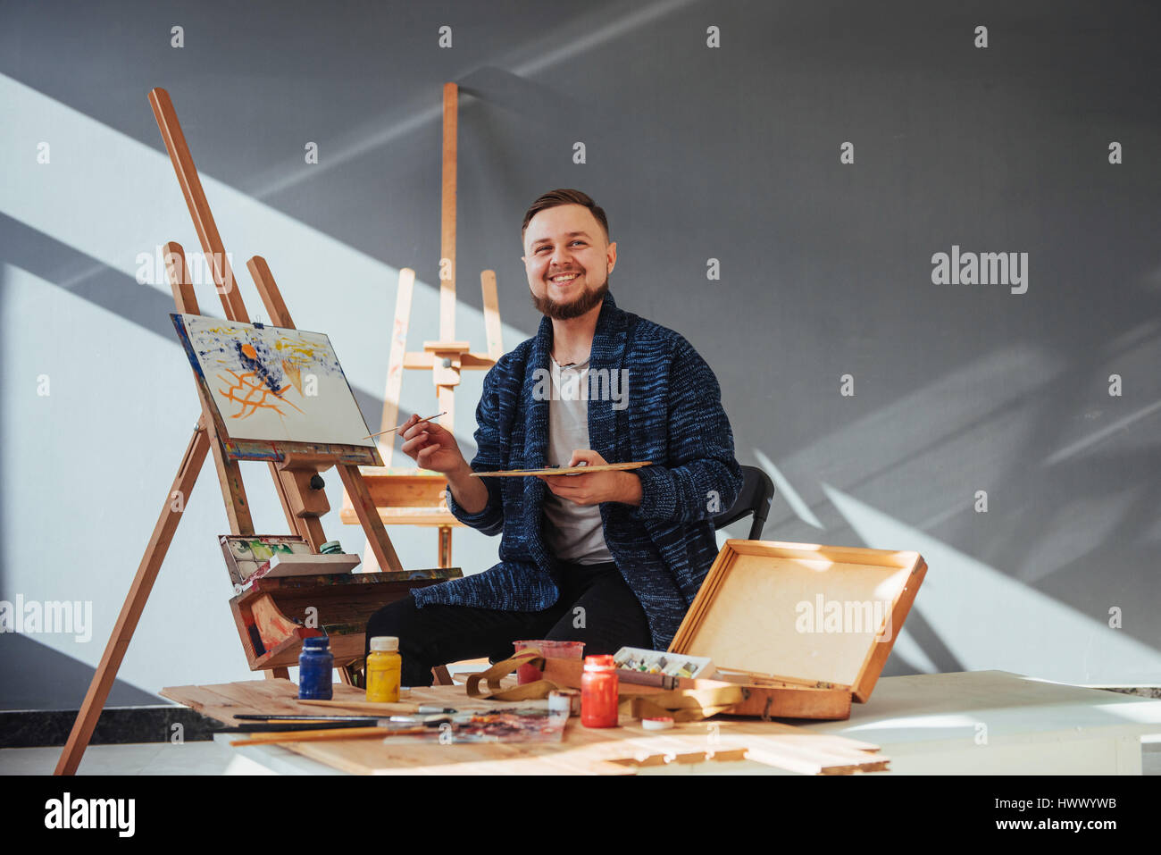artist painting a picture in a studio Stock Photo - Alamy