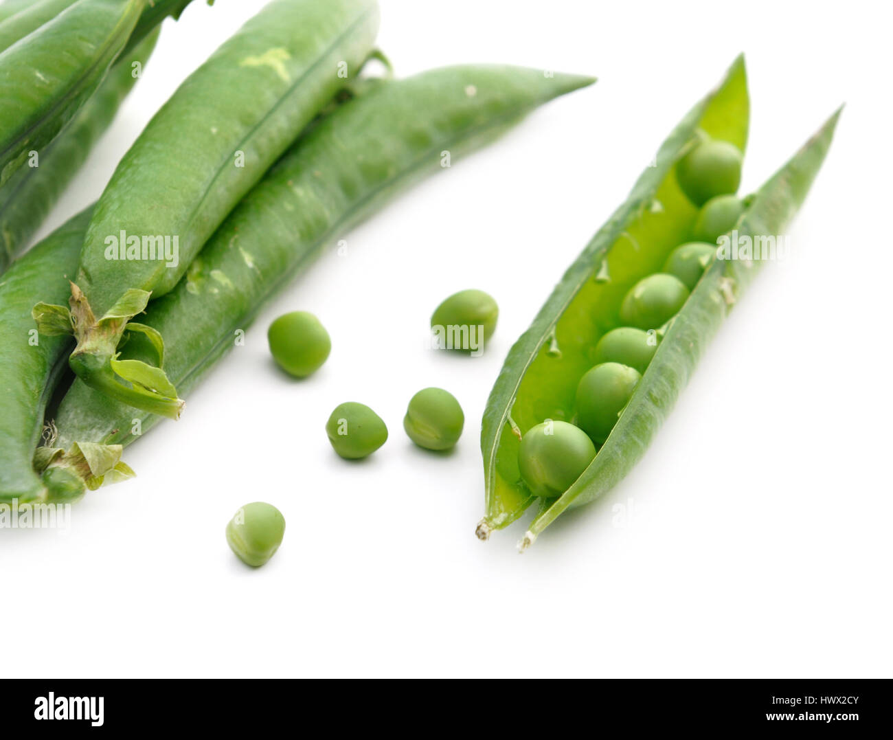 peas on open pod isolated on white background Stock Photo - Alamy