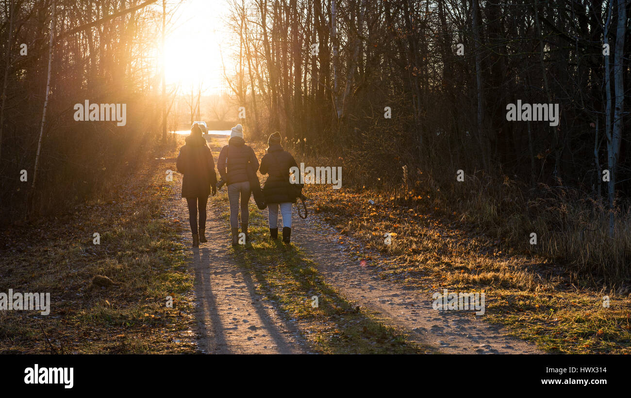 PEOPLE WALKING ON the road in the countryside with trees in surrounding ...