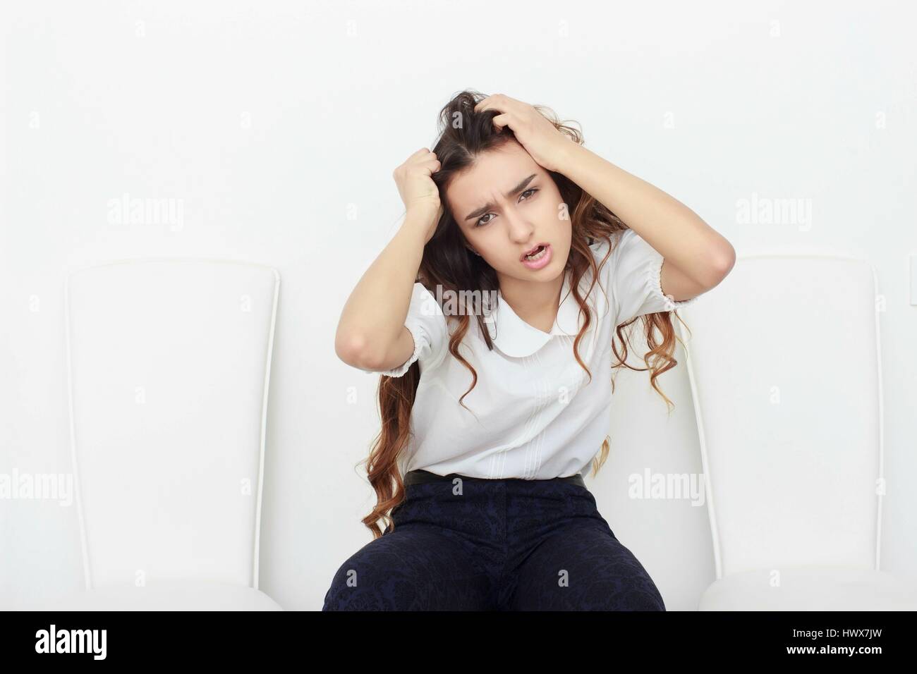 A beautiful girl is sitting on chair and angry Stock Photo - Alamy
