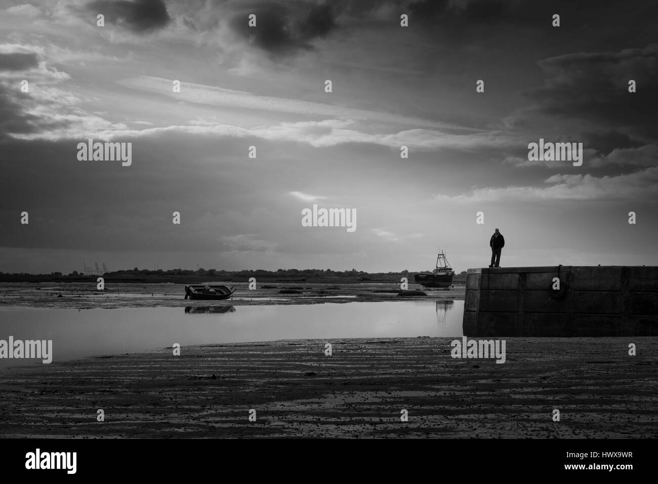 Man standing on fishing Black and White Stock Photos & Images - Alamy