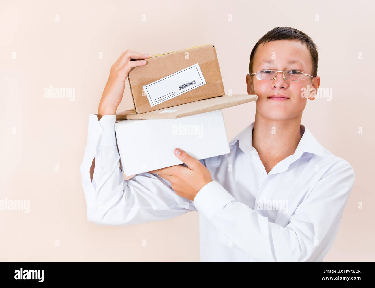 Boy postman with a parcel on his shoulder Stock Photo - Alamy